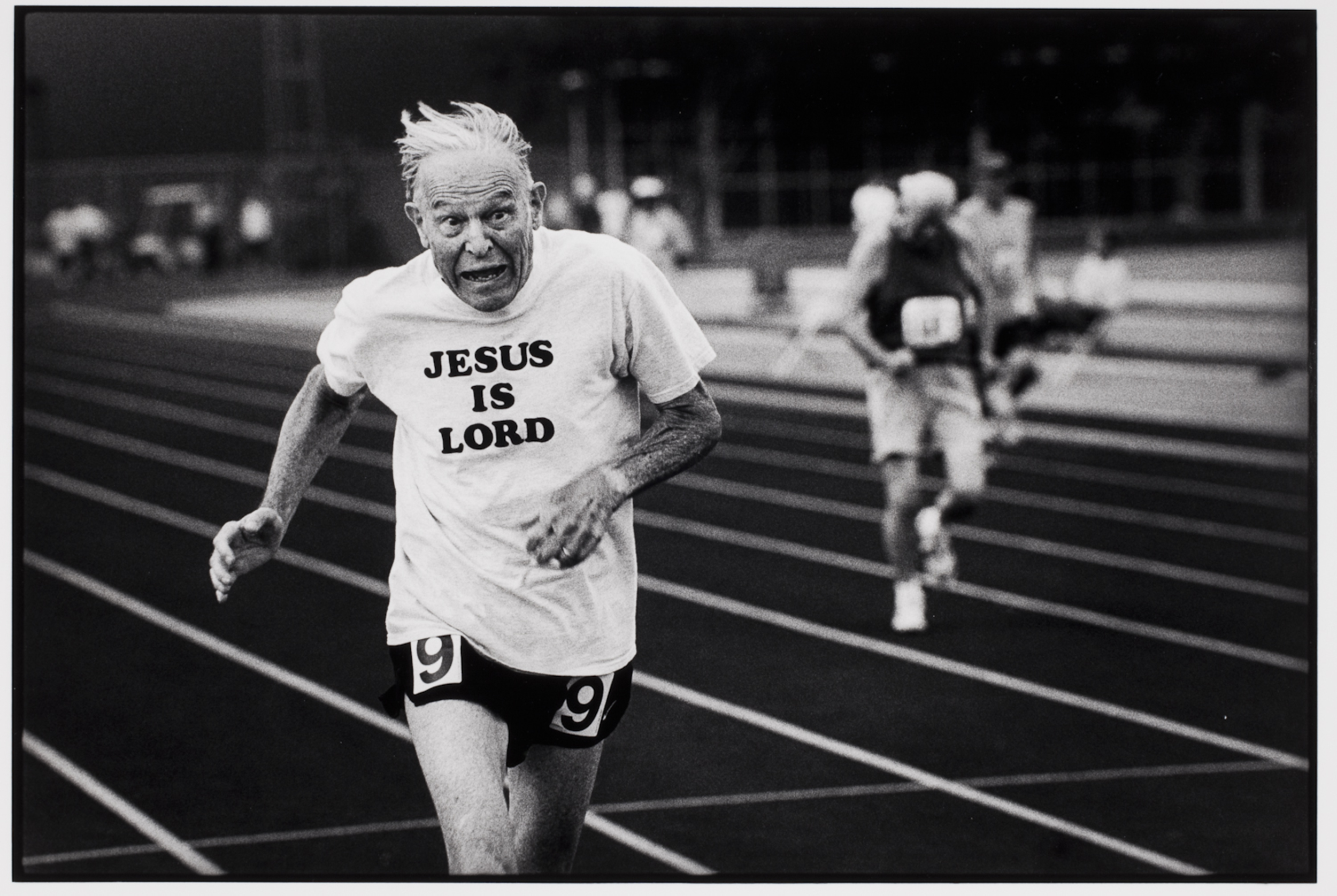 A sprinter crosses the finish line during a track event at the 2001 ...