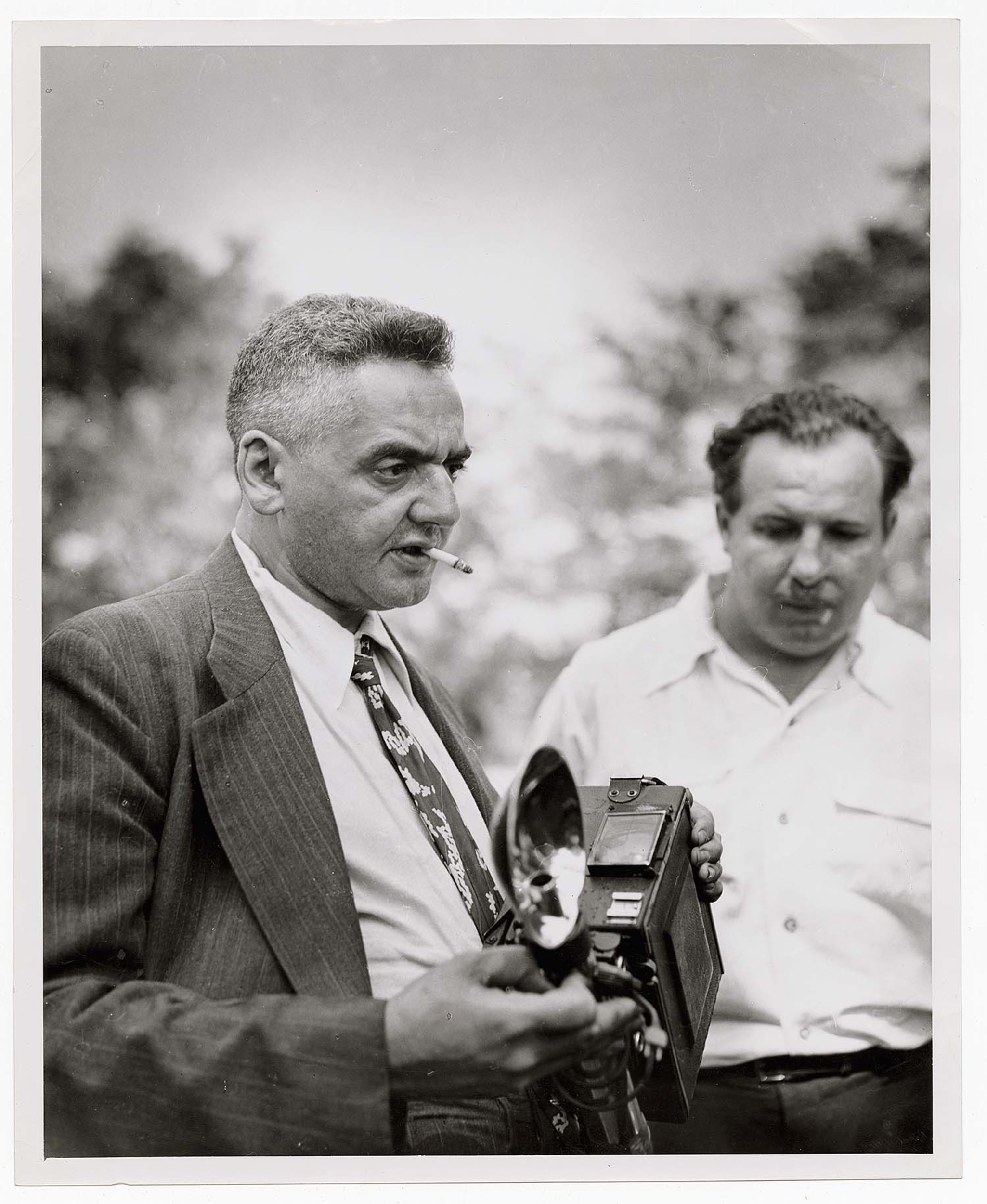 [Portrait of Weegee (Arthur Fellig) holding camera at demo on crime ...