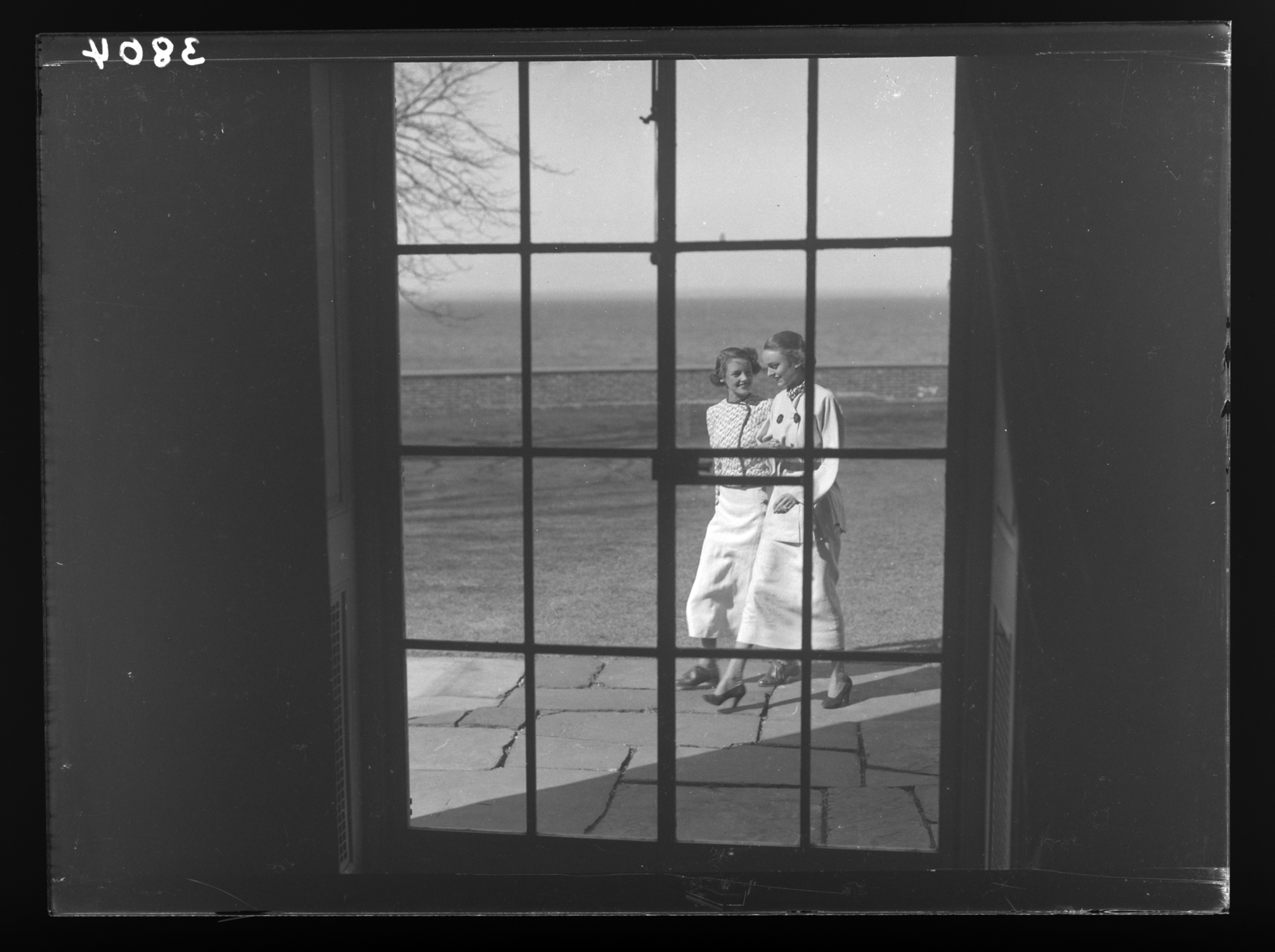 [View through window of two women walking] | International Center of ...