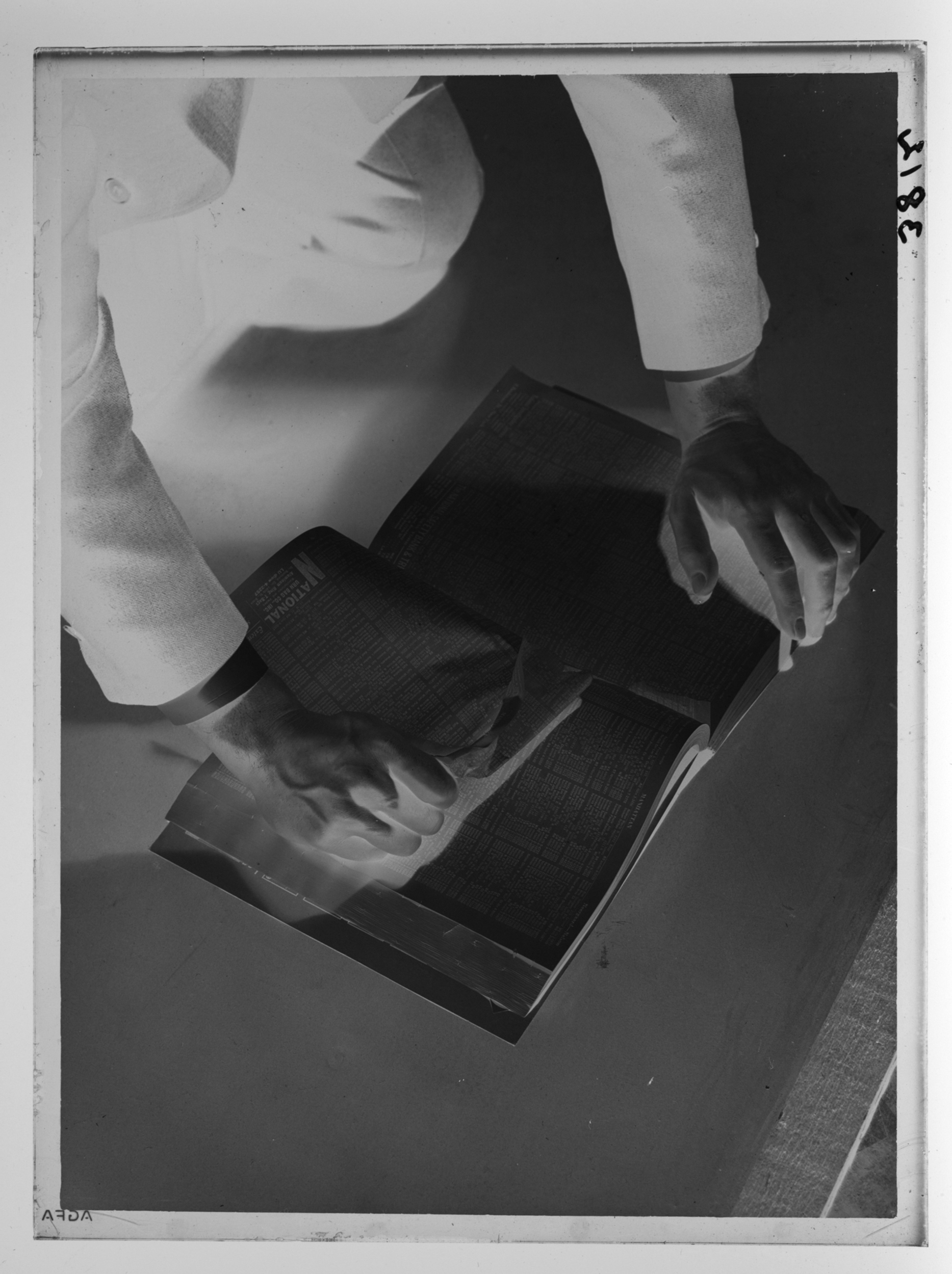 [Man ripping page from Manhattan telephone book] | International Center ...