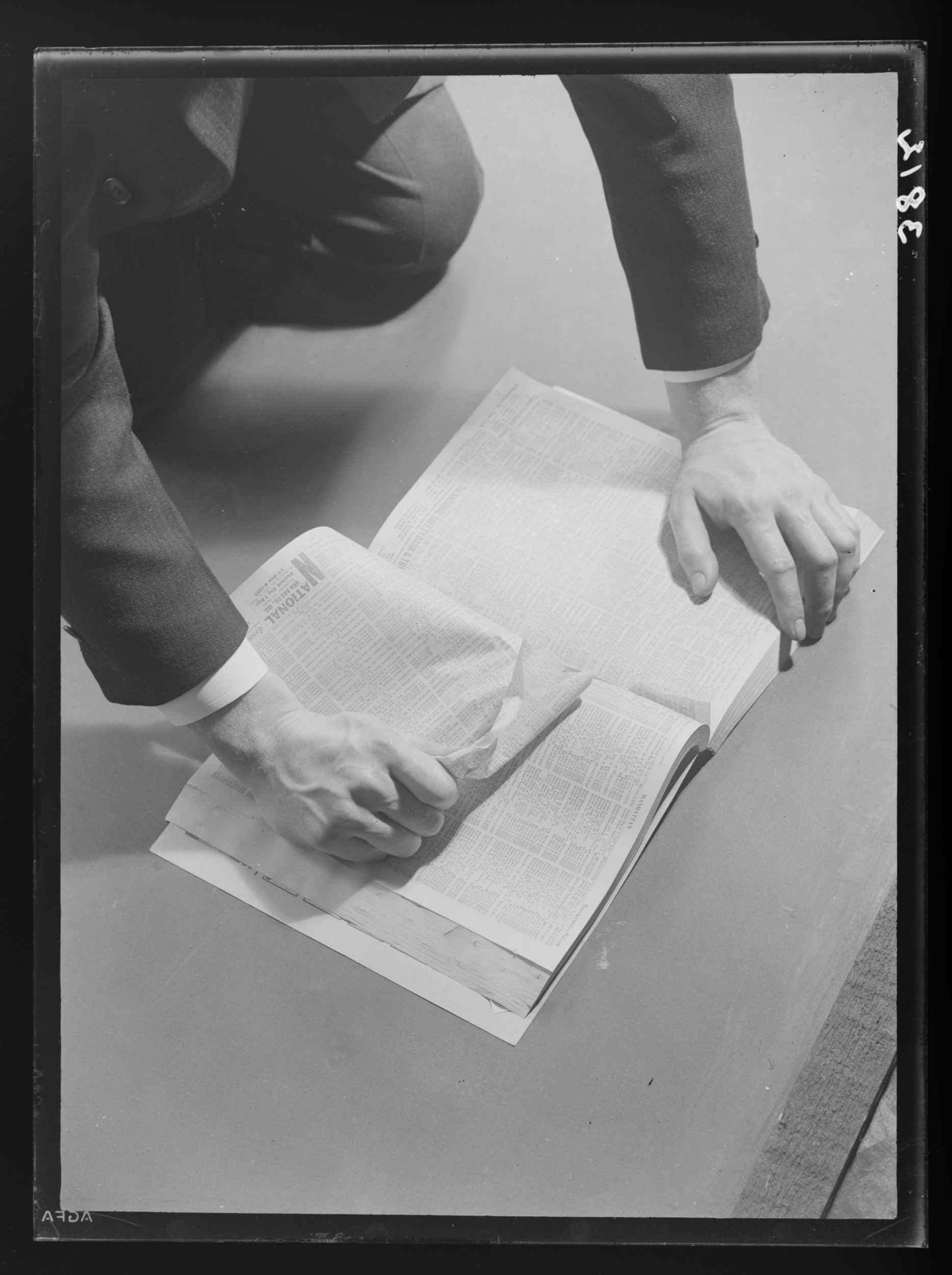 [Man ripping page from Manhattan telephone book] | International Center ...