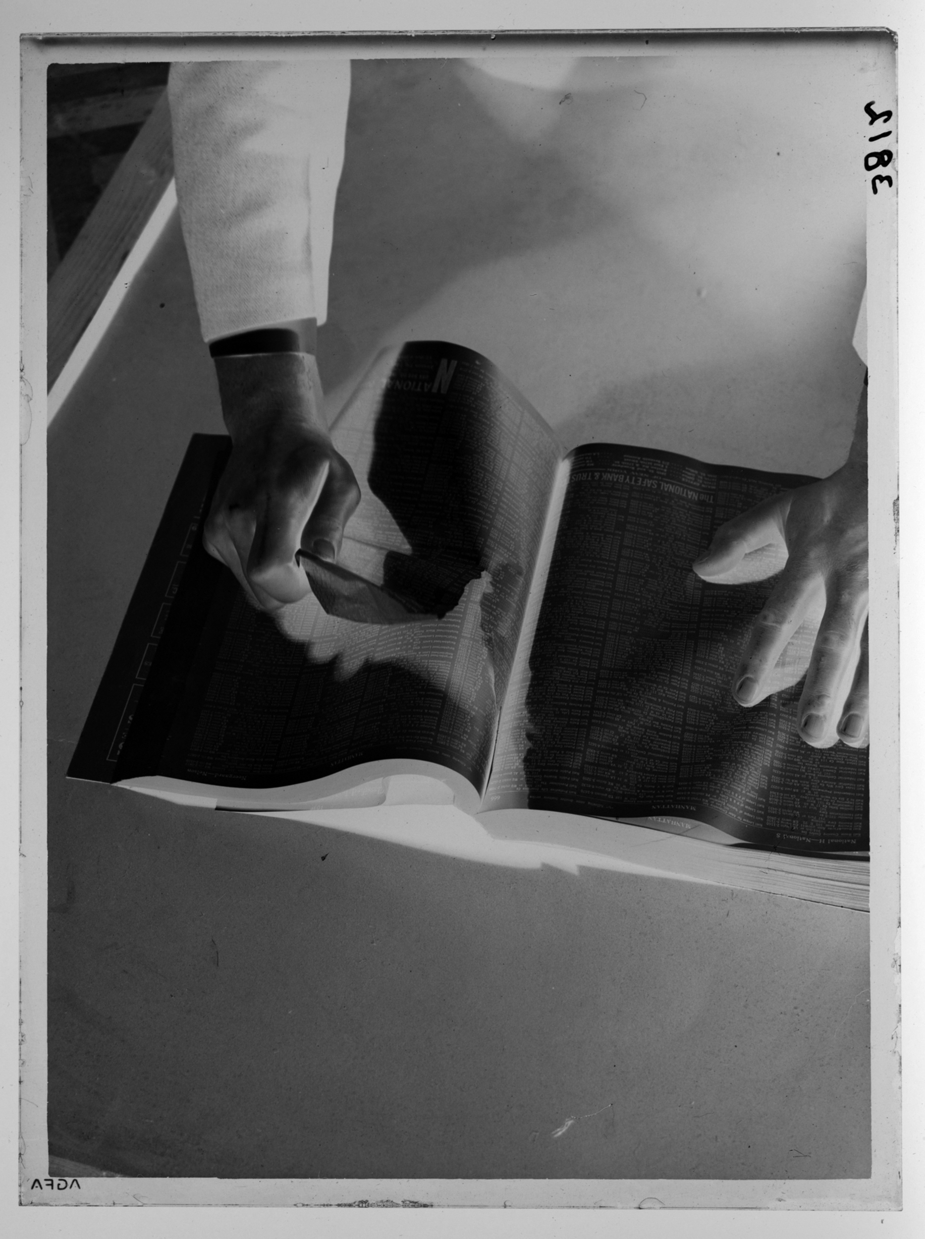 [Man ripping page from Manhattan telephone book] | International Center ...
