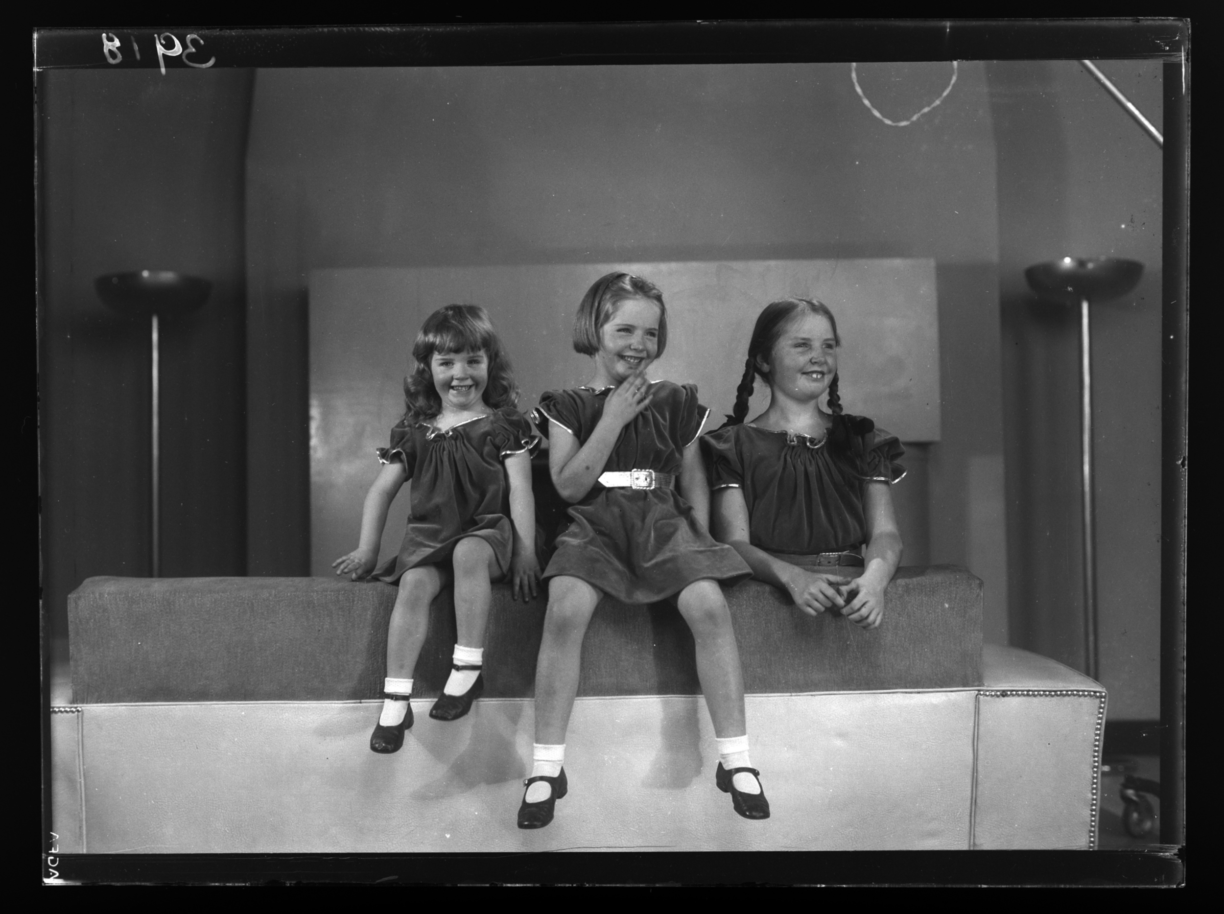 [Three girls sitting on couch] | International Center of Photography