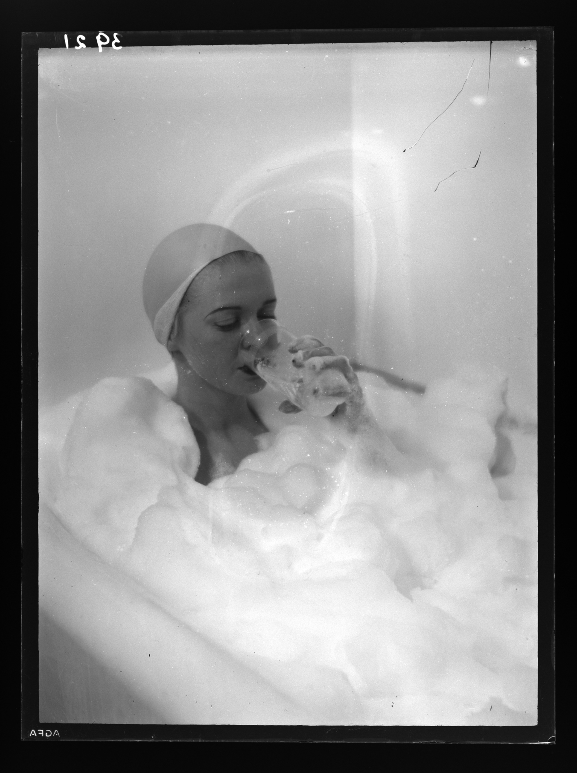 [Woman drinking in bubble bath] | International Center of Photography