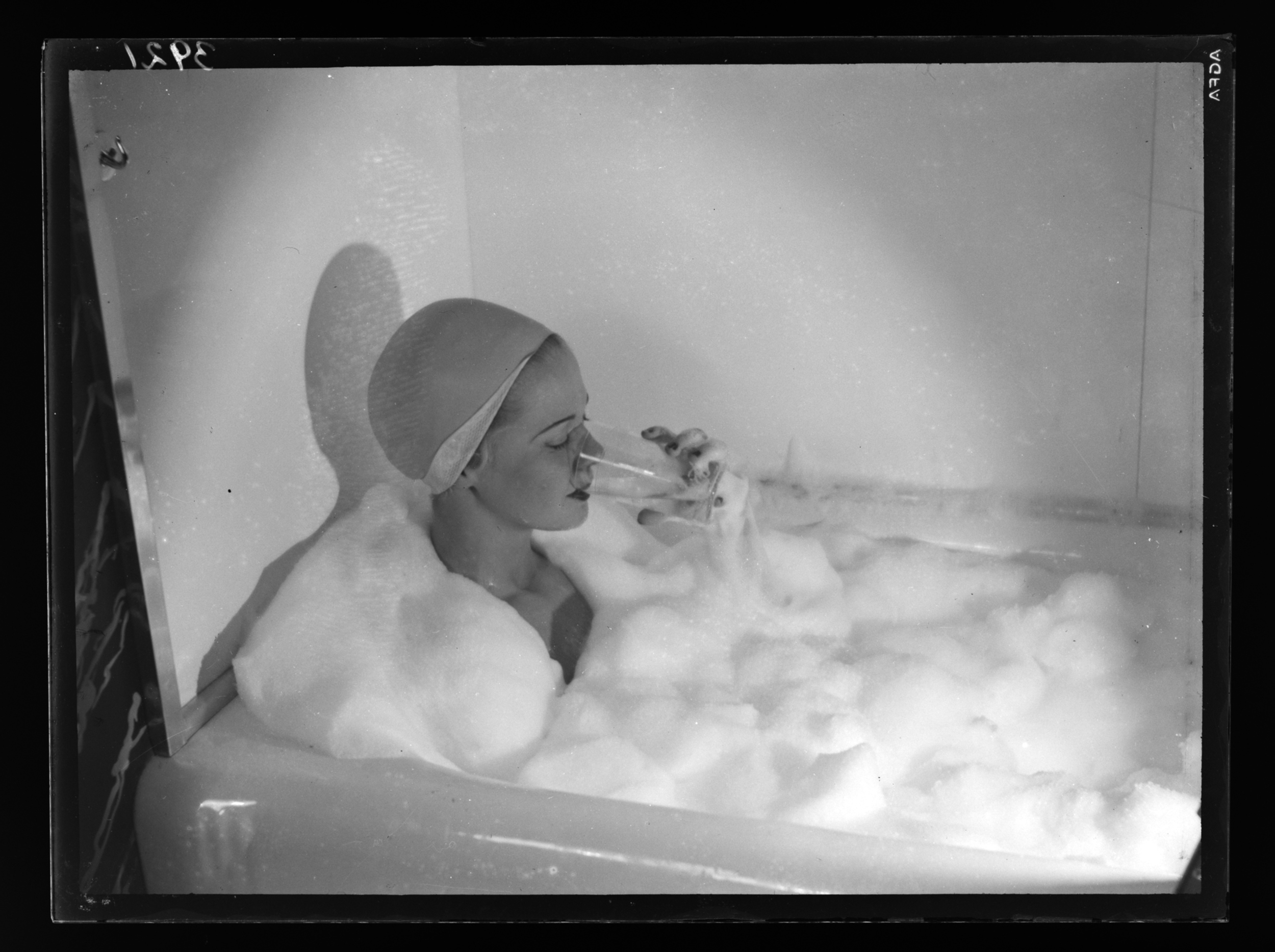 [Woman drinking in bubble bath] | International Center of Photography