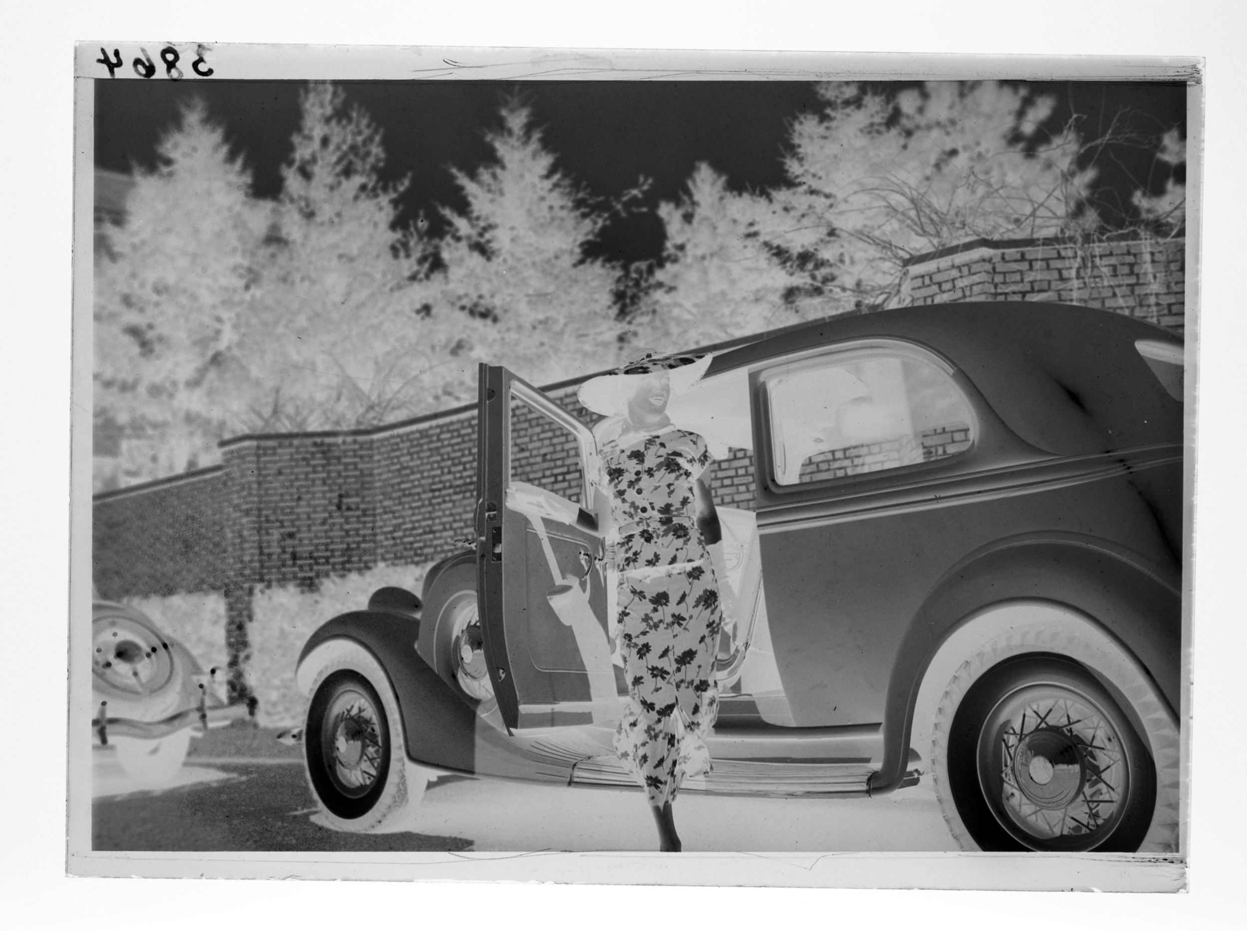 [Woman exiting car] | International Center of Photography
