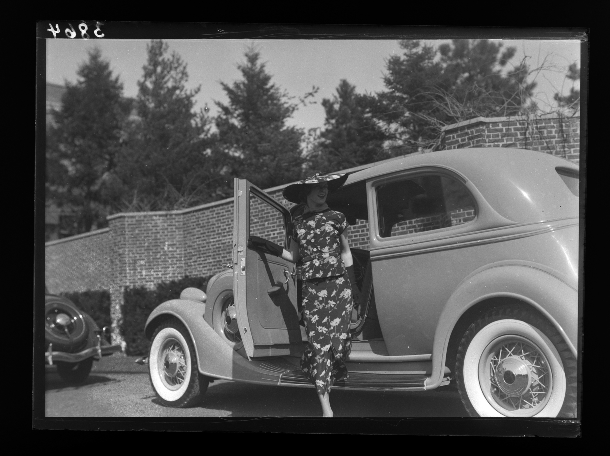 [Woman exiting car] | International Center of Photography