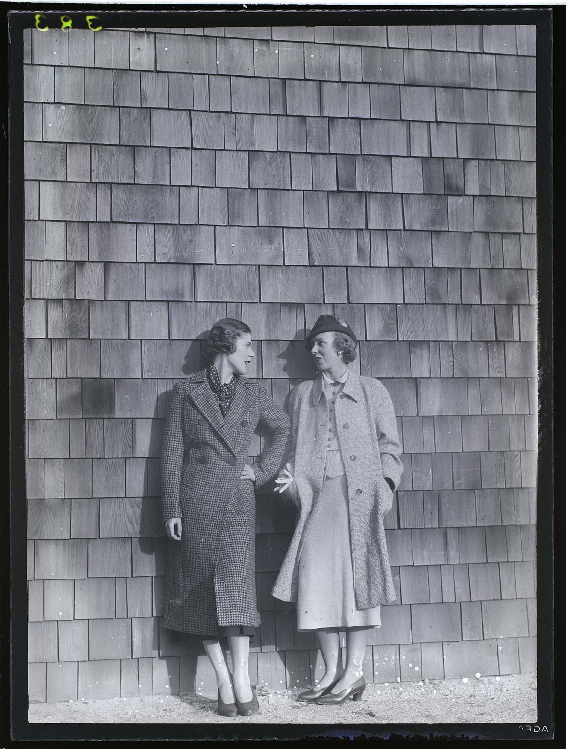 [Two women leaning against building] | International Center of Photography