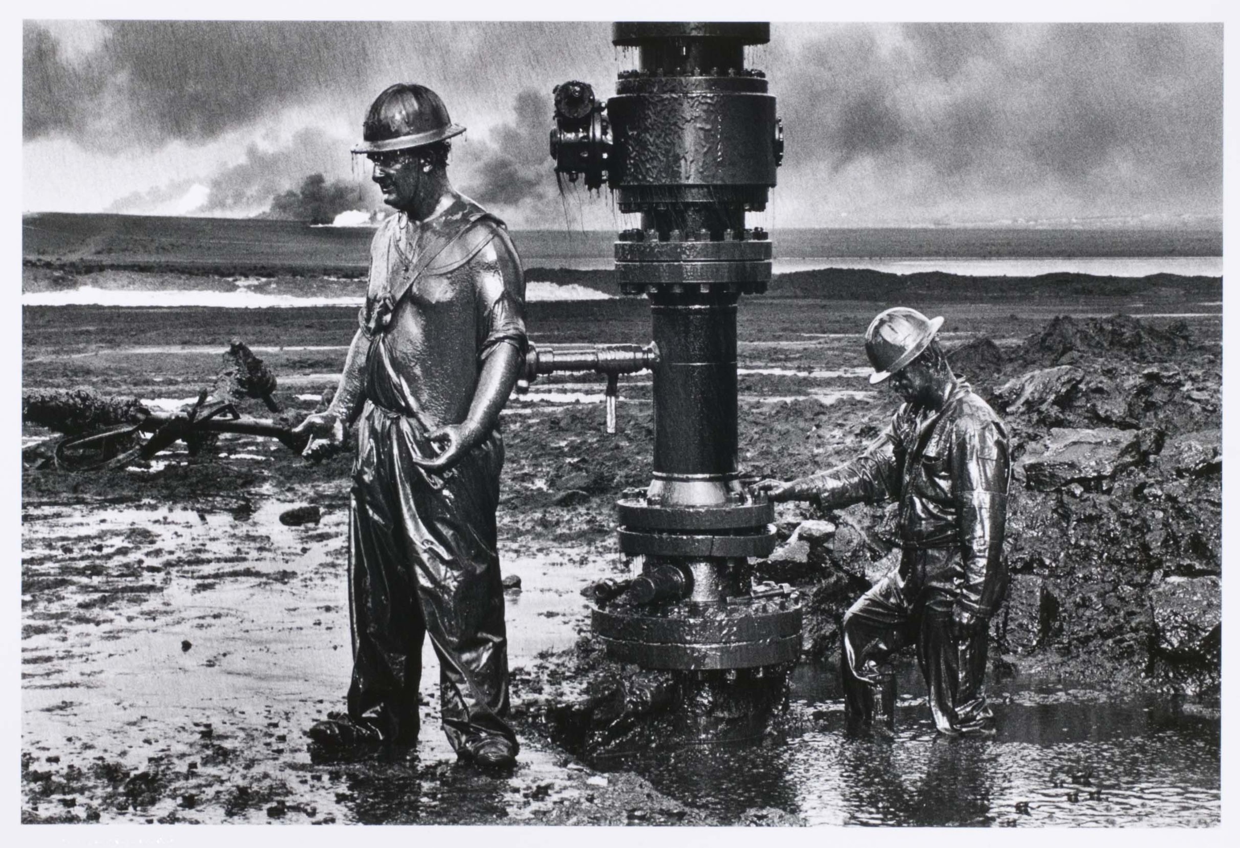 Workers place a new wellhead in an oil well that had been damaged by ...