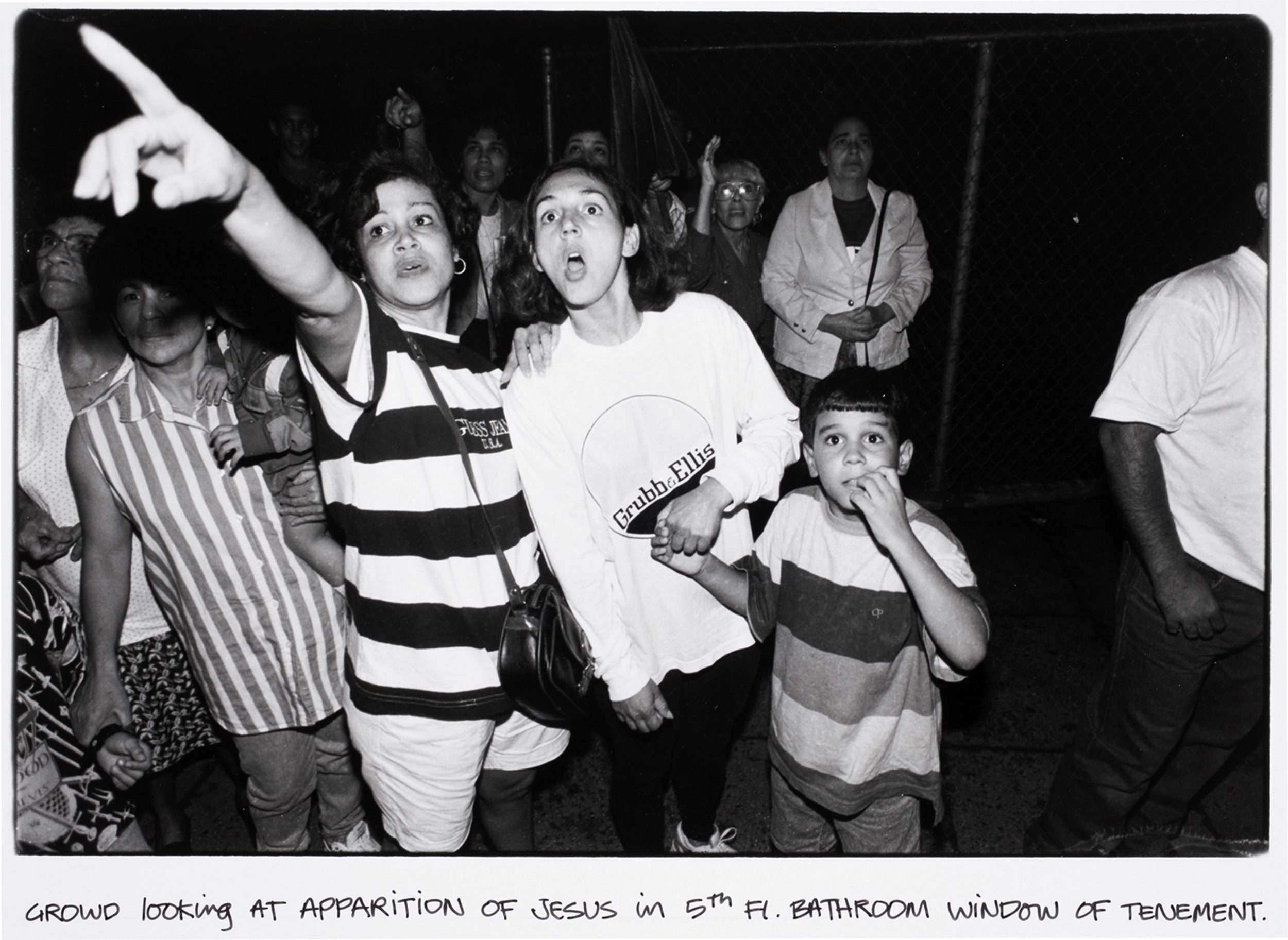 Crowd looking at apparition of Jesus in 5th floor bathroom window of ...