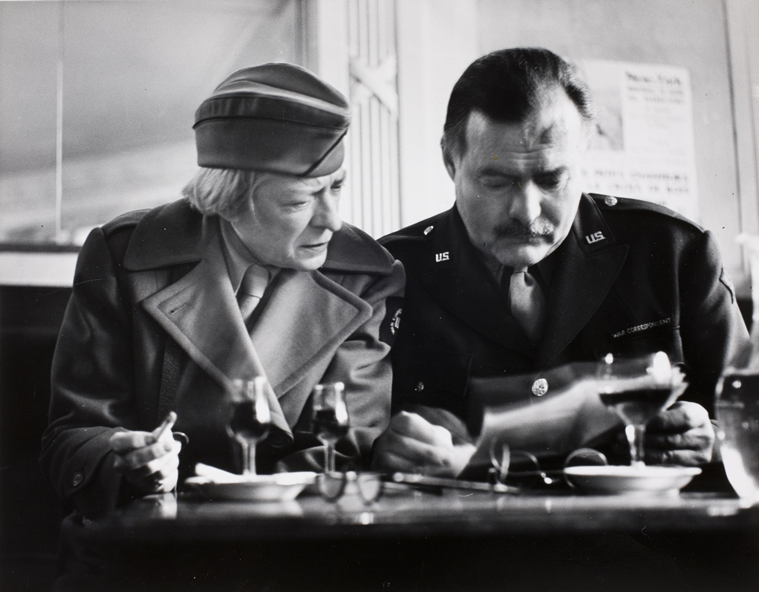 [Janet Flanner and Ernest Hemingway reading manuscript together in a ...