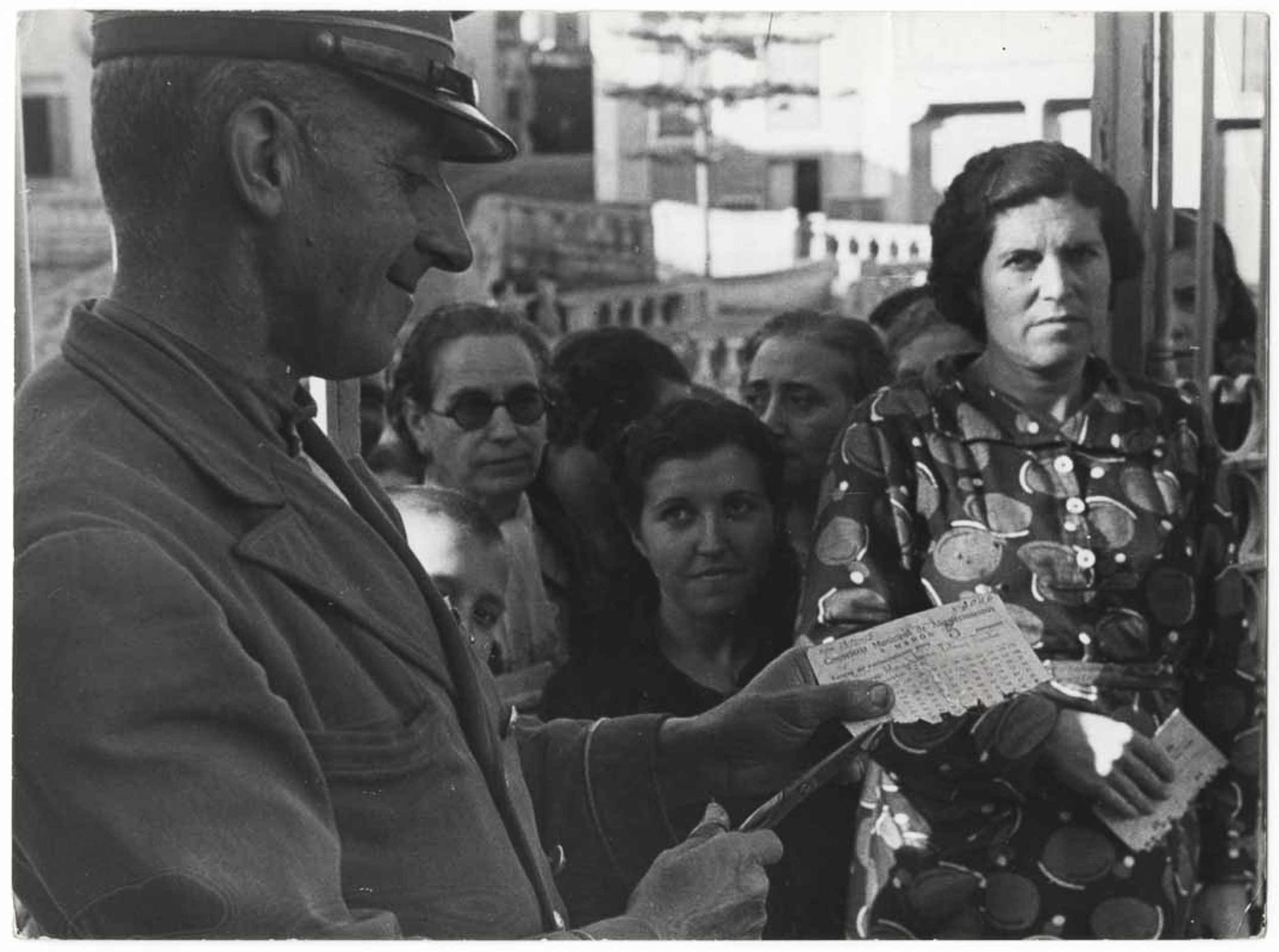 [Army soldier cutting a ration card with a group of women, Minorca ...