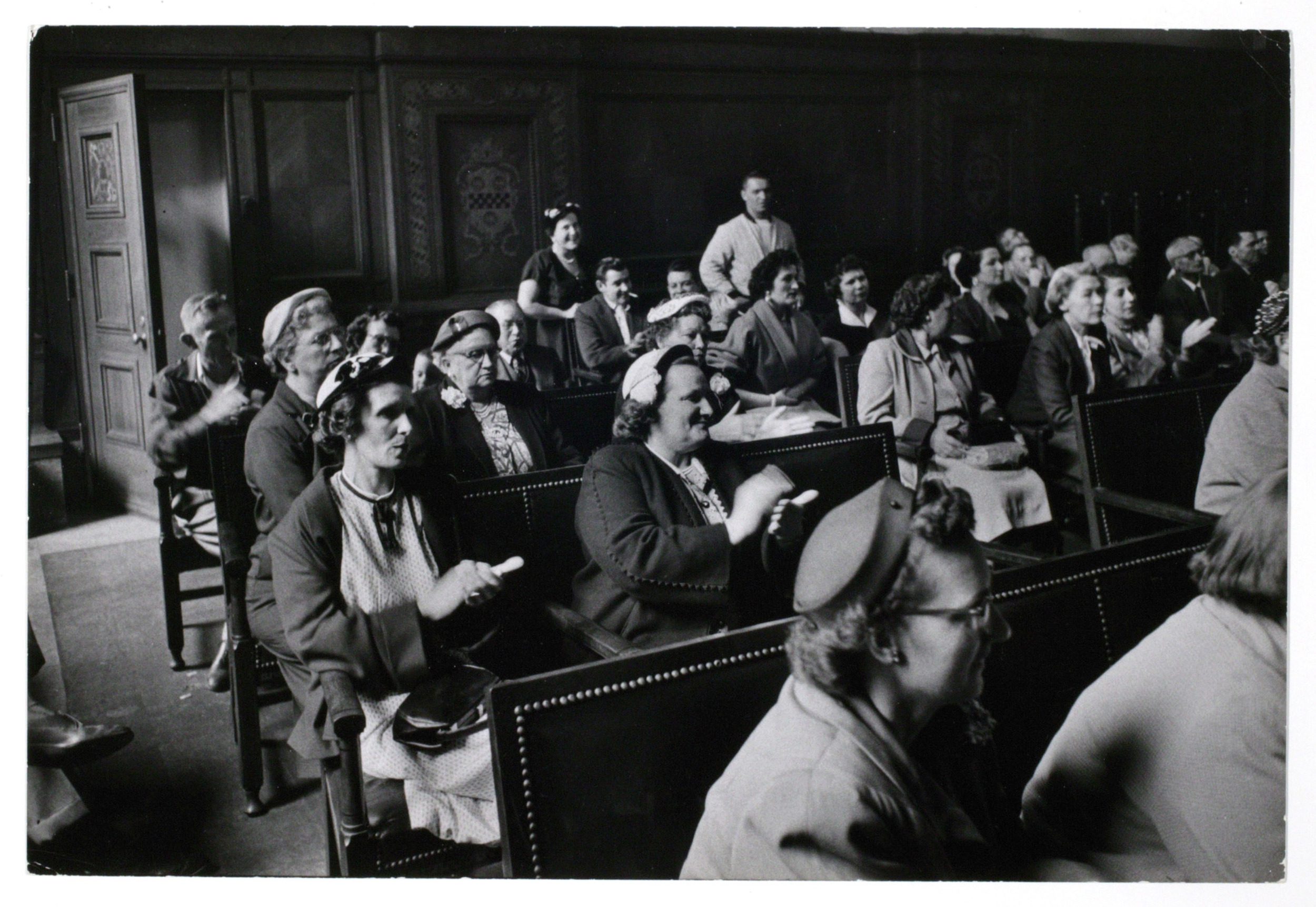 Women seated in rows at back of courtroom, clapping | International ...