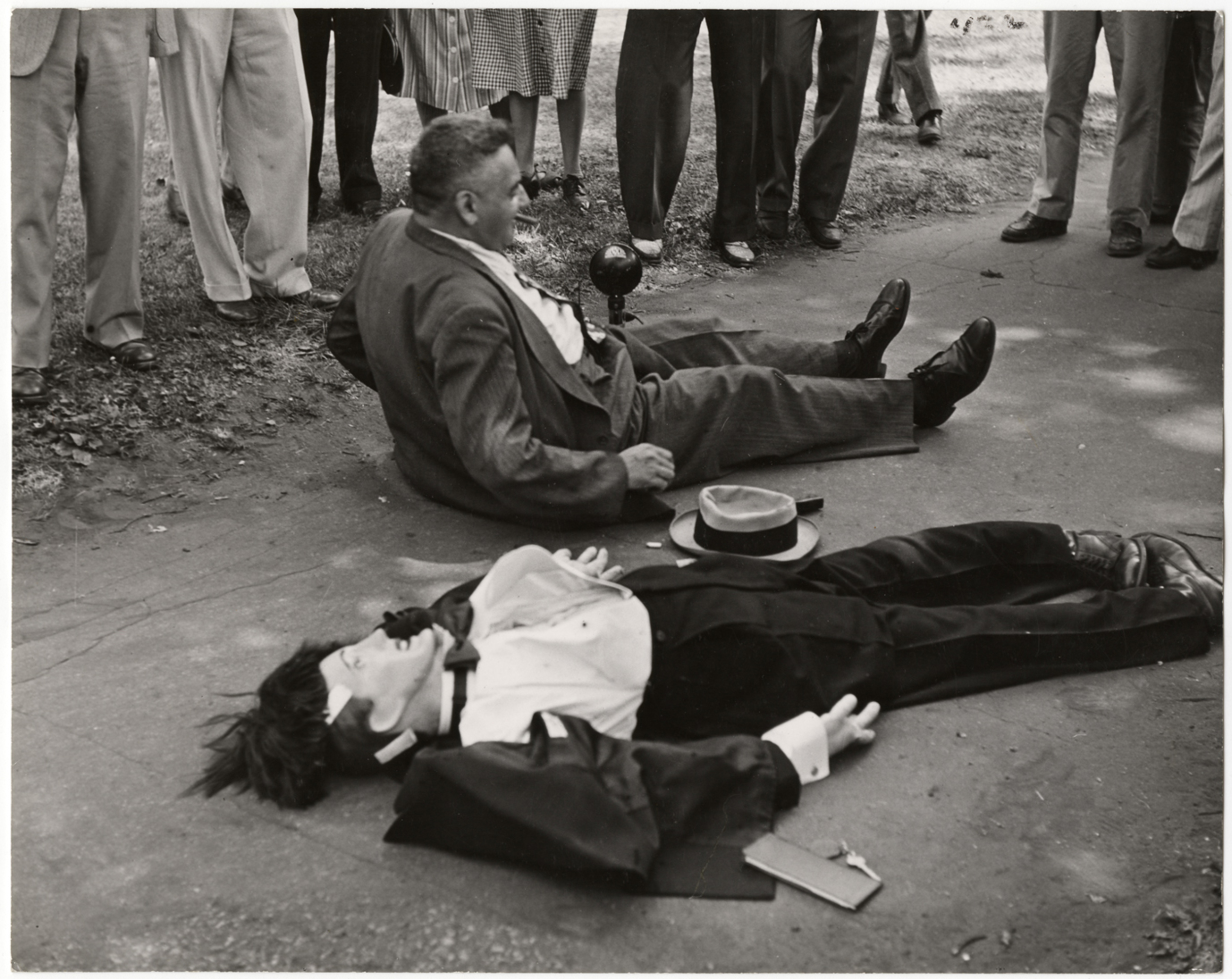 Weegee gets down bedside the dummy to pose for gag shots by the ...