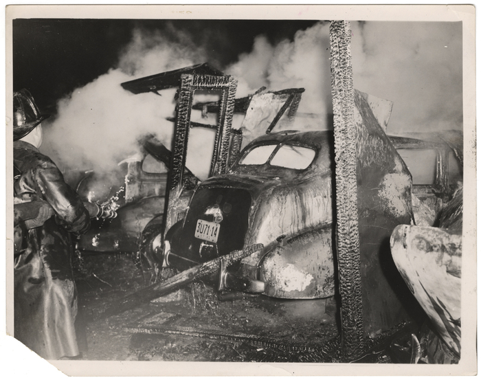 [Fire fighter and burning cars] | 1International Center of Photography