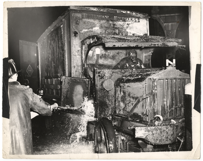 [Fire in a truck with burnt man] | 1International Center of Photography