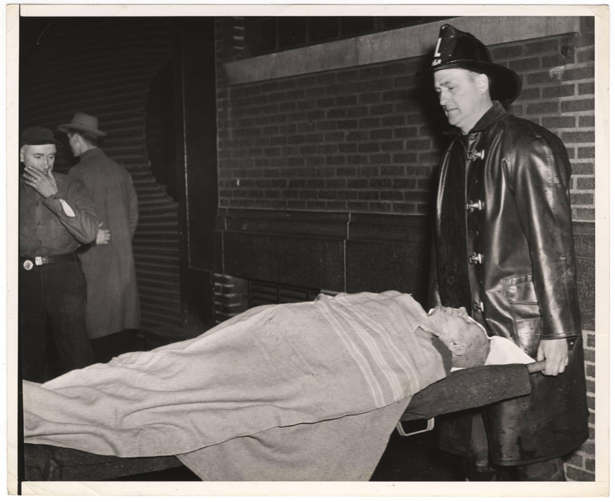 [Firefighter carrying Injured or dead person on stretcher ...