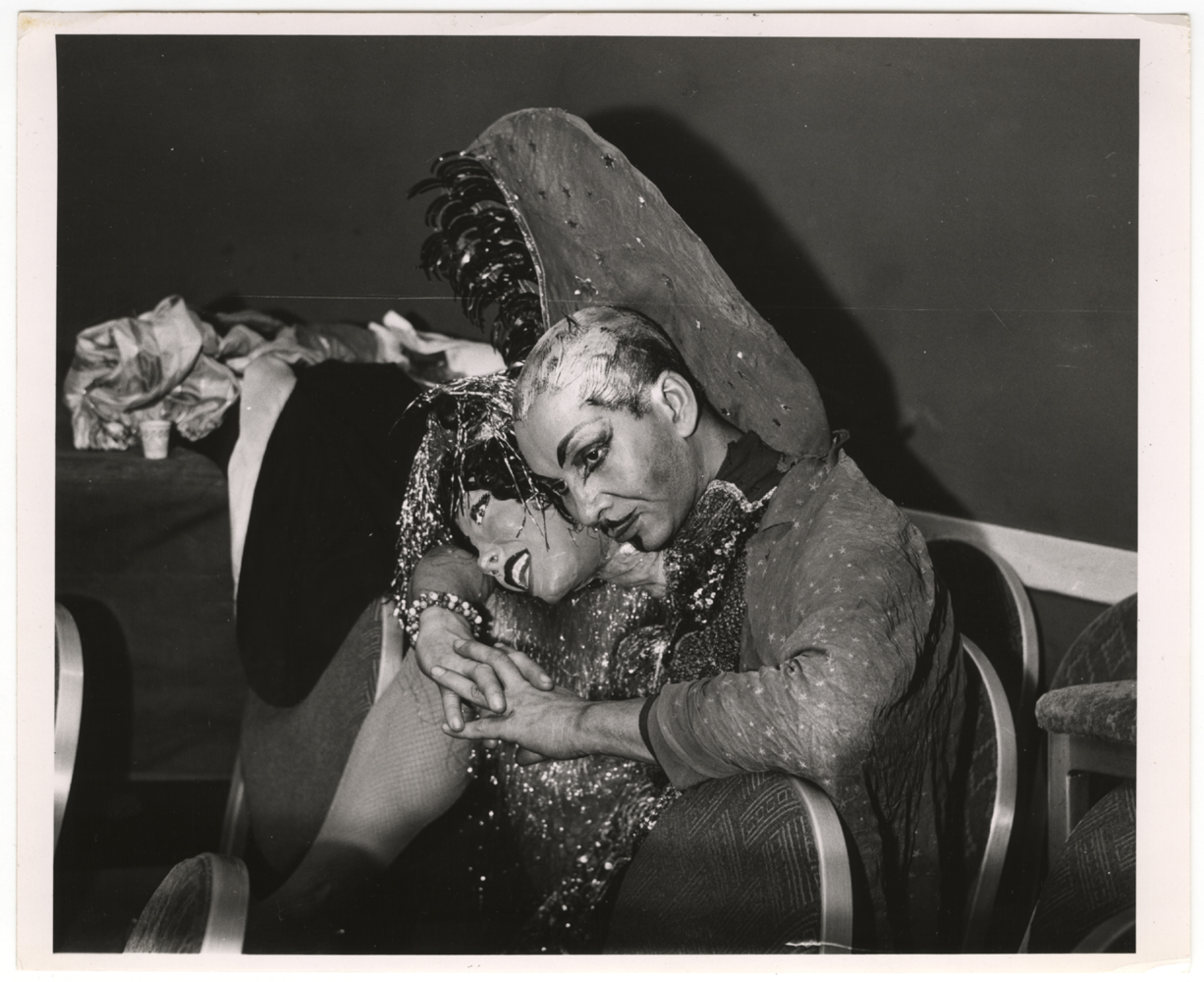 [man wearing two headed costume seated] | International Center of ...