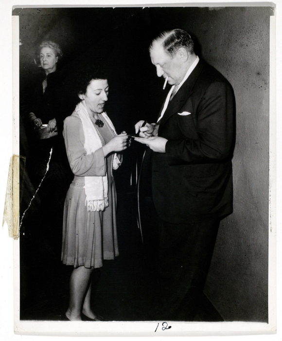 [Man signing autograph] | 1International Center of Photography