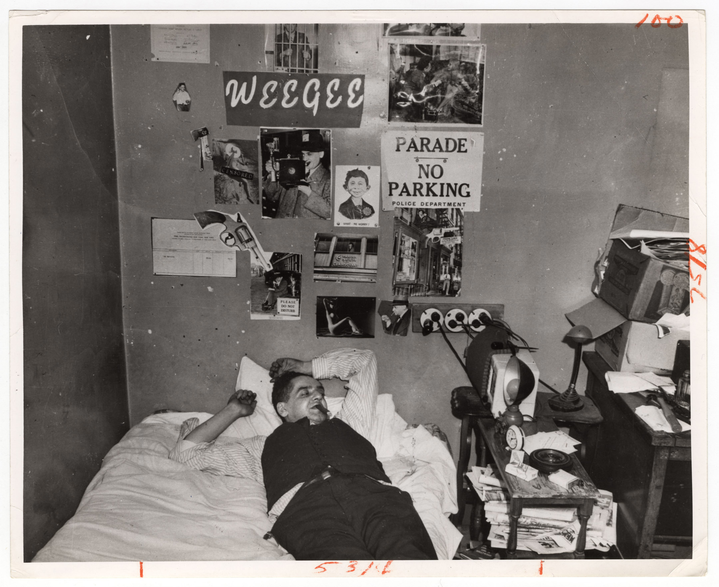 [Weegee lying on bed in his studio, New York] | International Center of ...