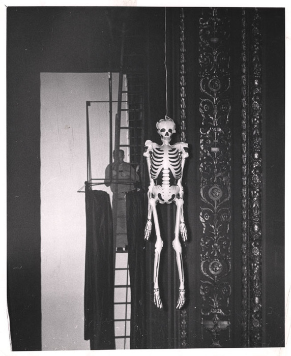 [Man hanging skeleton from movie theater ceiling for screening of ...