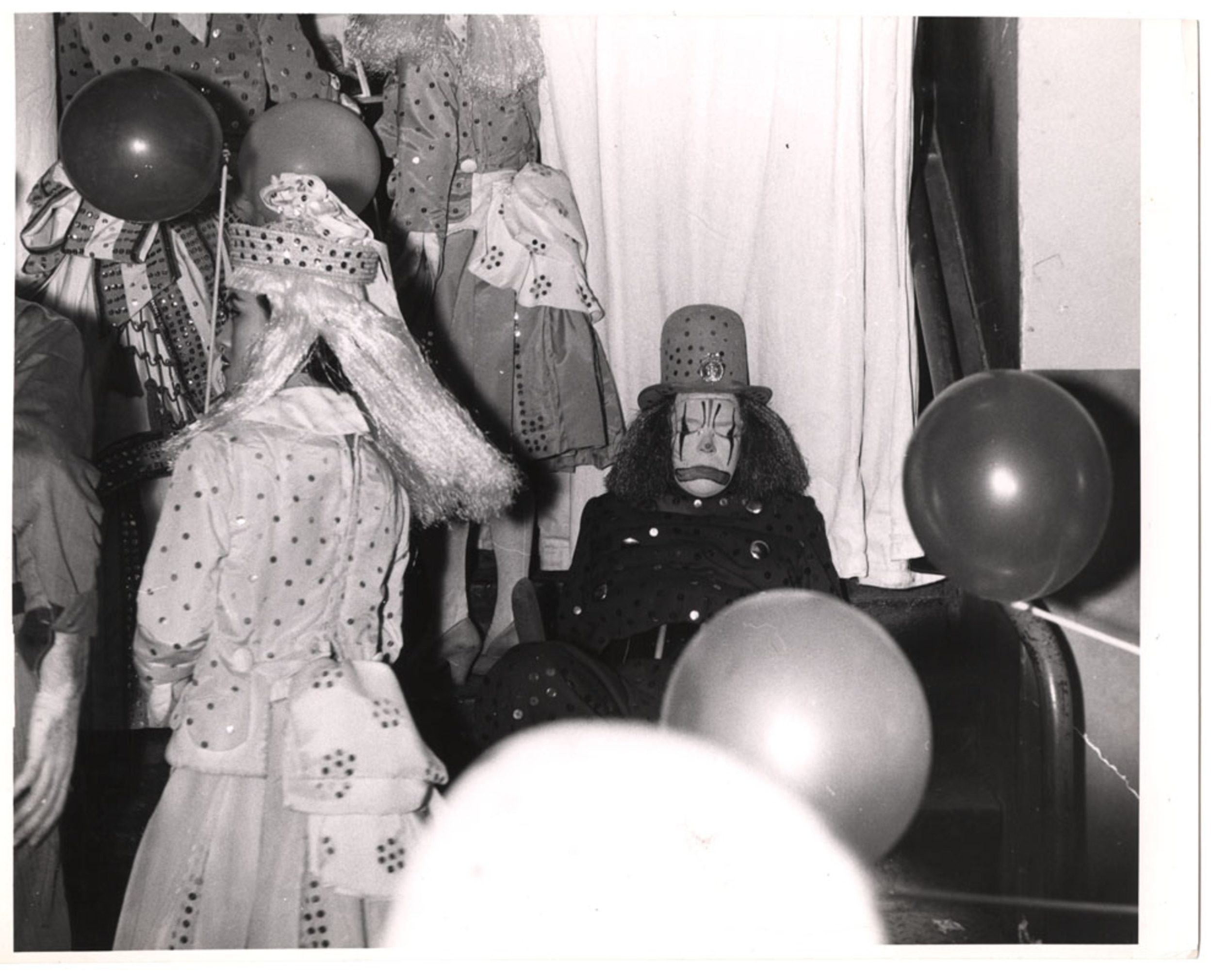 Clown sleeping, with balloons | International Center of Photography