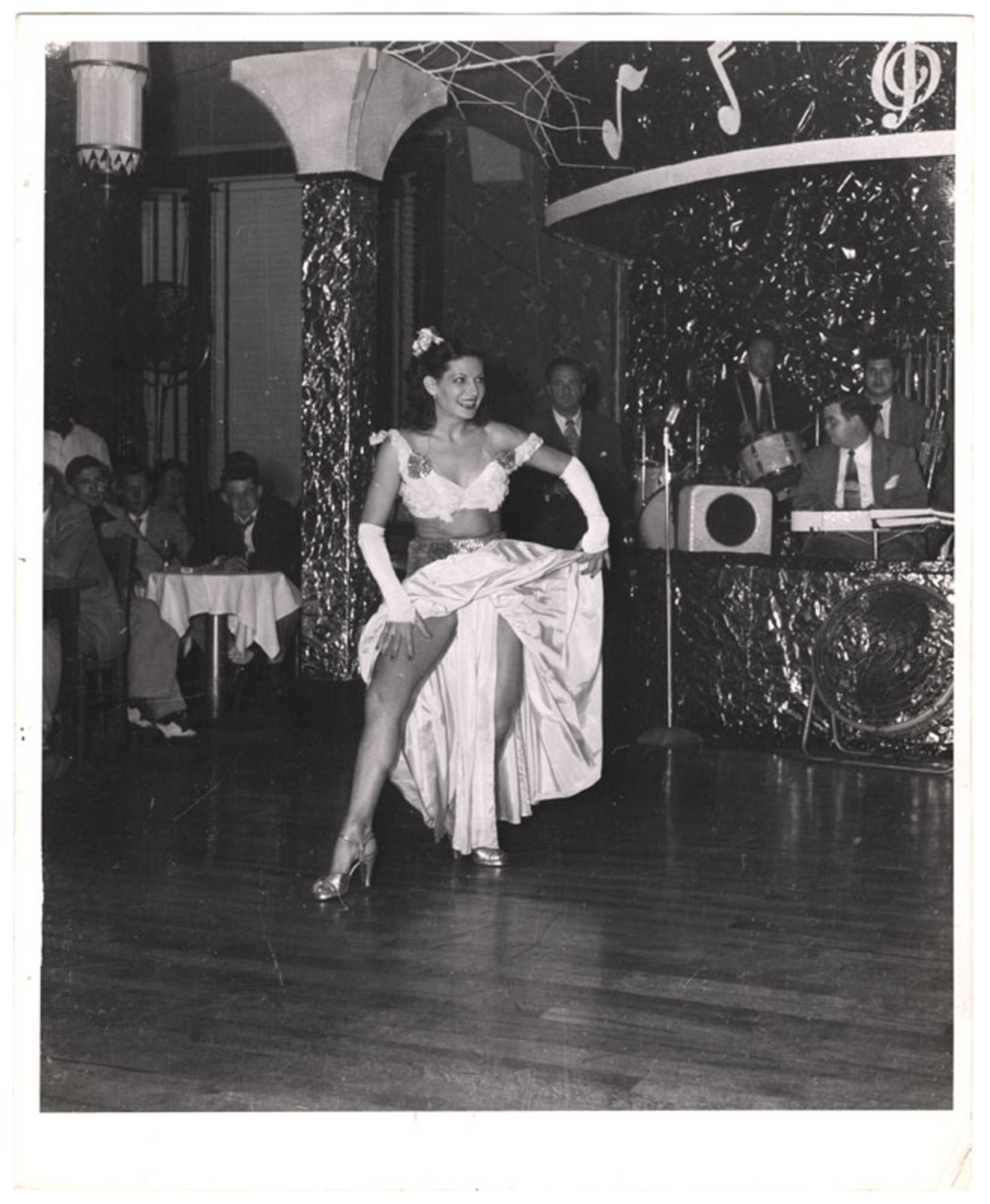 Showgirl dancing in front of band | International Center of Photography