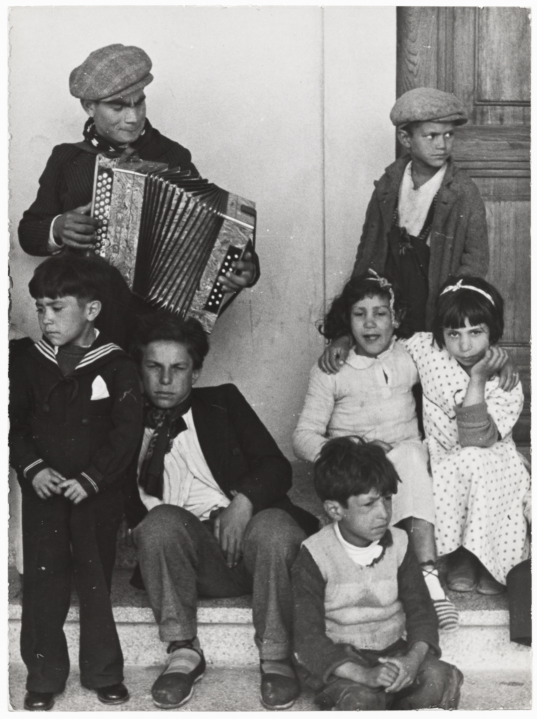 [Gypsy musician and six gypsy children on a sidewalk, France ...