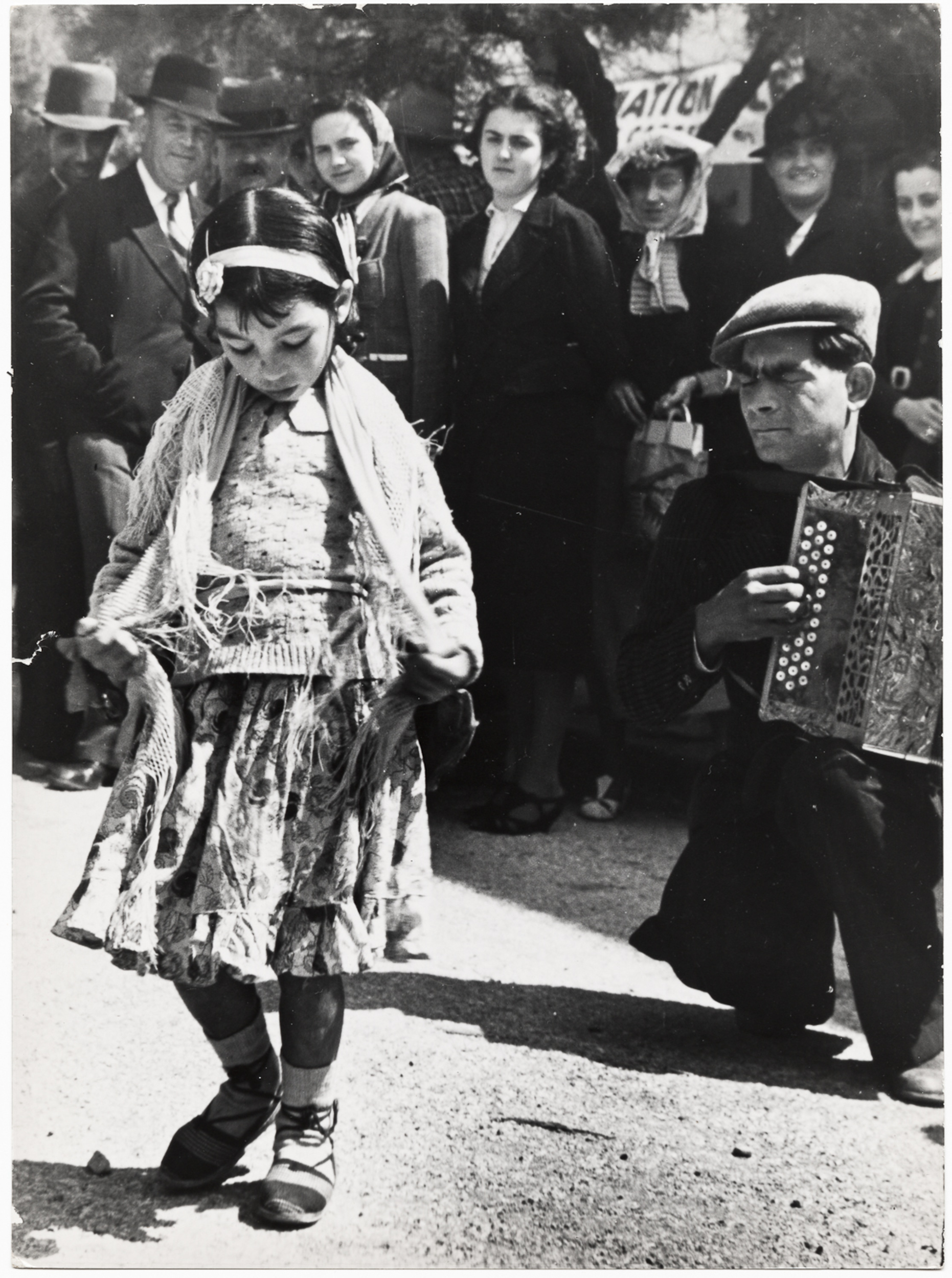 [Crowd of people watching and hearing a gypsy musician and a a little ...