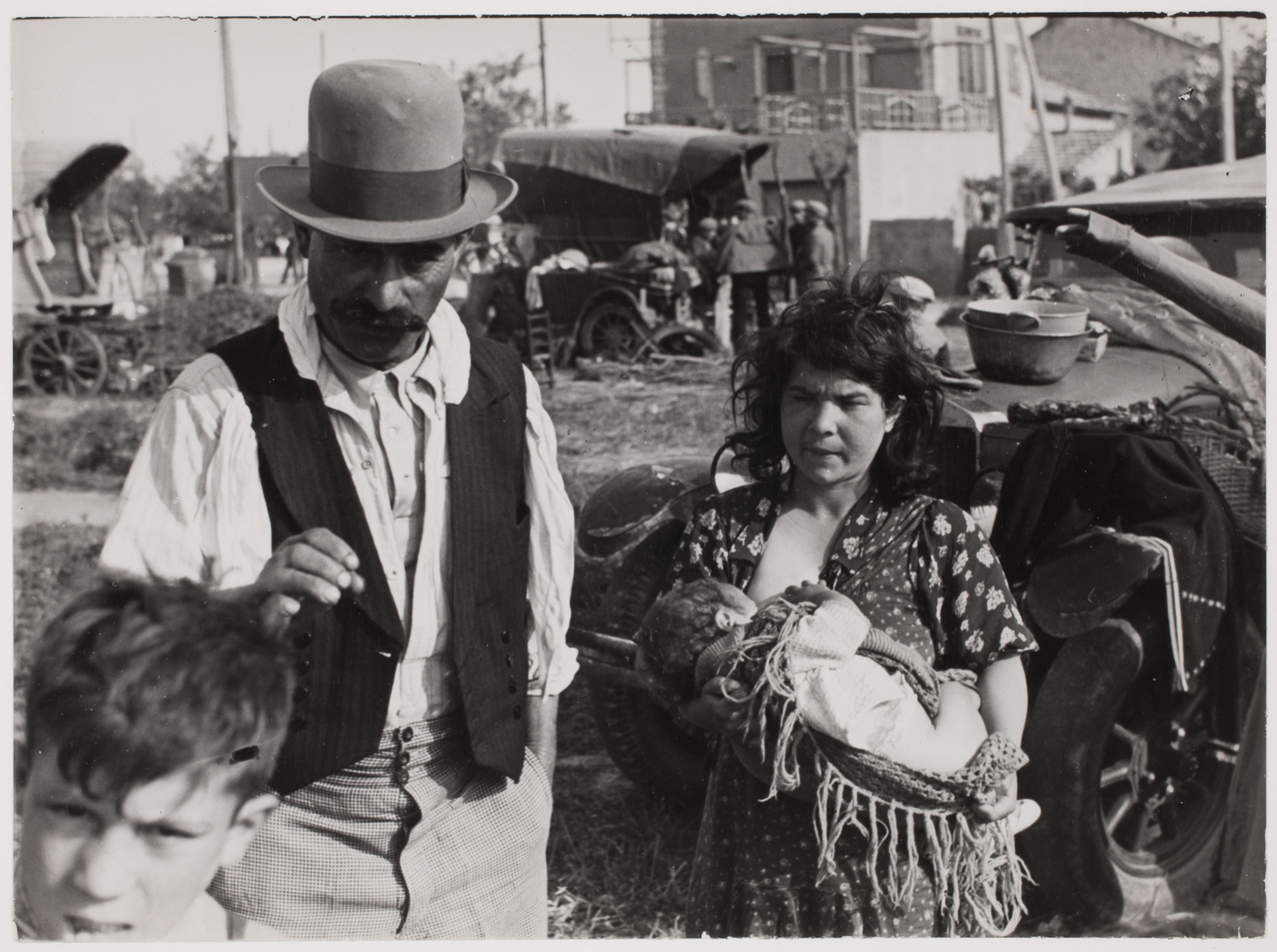 [Man, a woman breast feeding a baby and a boy in a gypsy camp, France ...