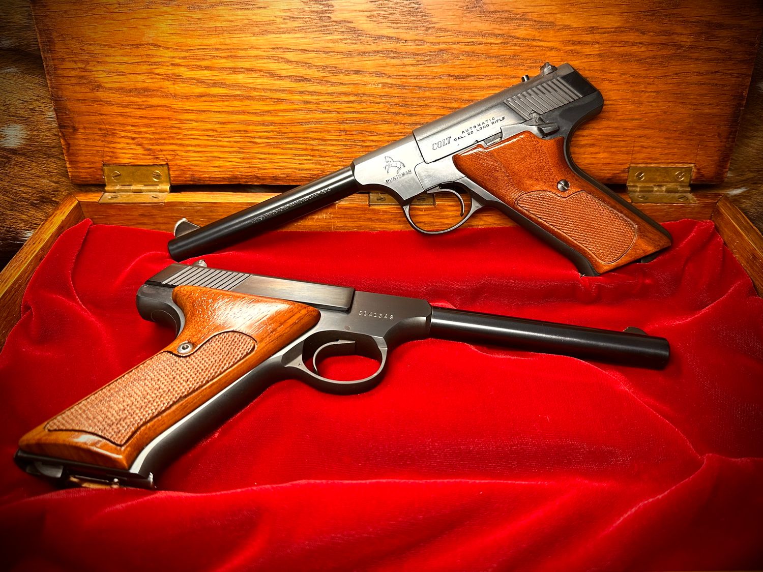 Two Consecutive Colt Huntsman .22LR Pistols with Wooden Display Box