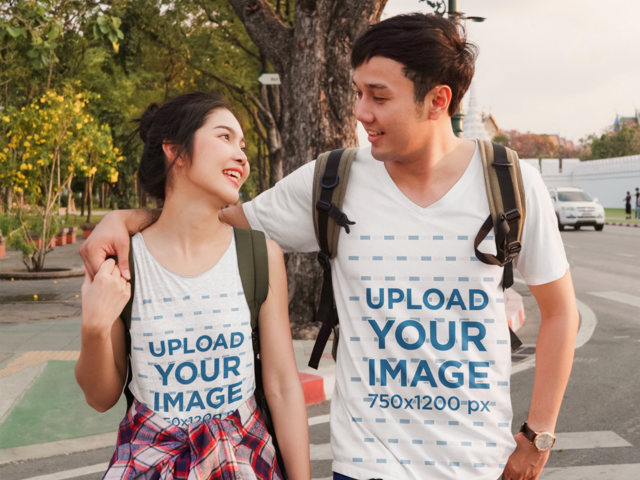 Placeit - Tank Top and T-Shirt Mockup of a Young Couple of Tourists Hugging