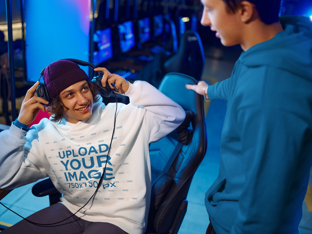 Placeit - Hoodie Mockup of a Teen Gamer Talking Happily with his Friend
