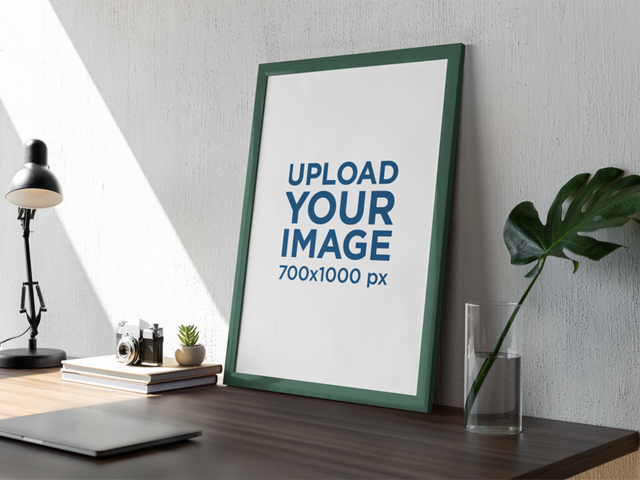 Placeit - Mockup of a Photo Frame Leaning Against a Wall Near a Small Plant