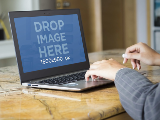 Placeit - Laptop Mockup of Business Woman Using Asus Zenbook at Work