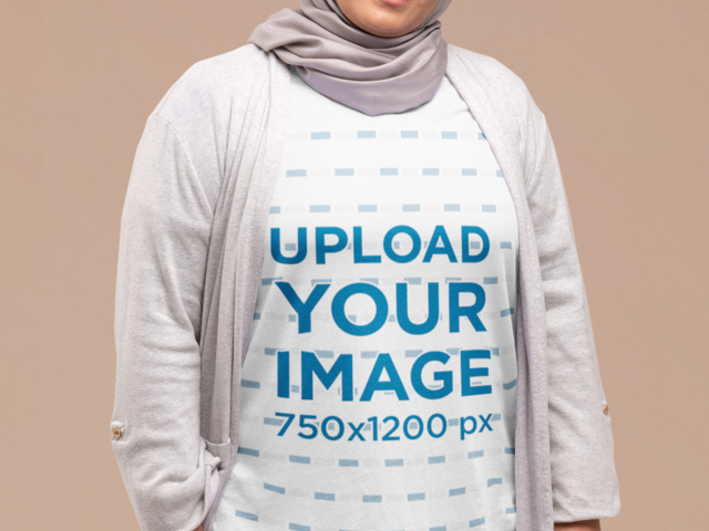 Placeit - T-Shirt Mockup of a Smiling Woman with a Hijab Posing at a Studio