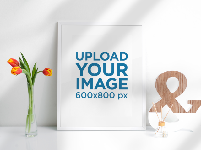 Placeit - Mockup of a Picture Frame Standing Against a White Wall and ...