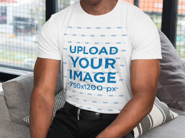 Placeit - T-Shirt Mockup of a Muscular Man in a Living Room