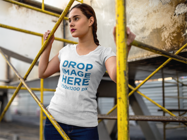 Placeit - T-Shirt Mockup of a Young Woman in an Industrial Scenario