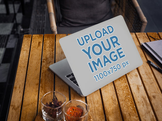 Placeit - Laptop Cover Mockup Featuring a Computer on a Wooden Table