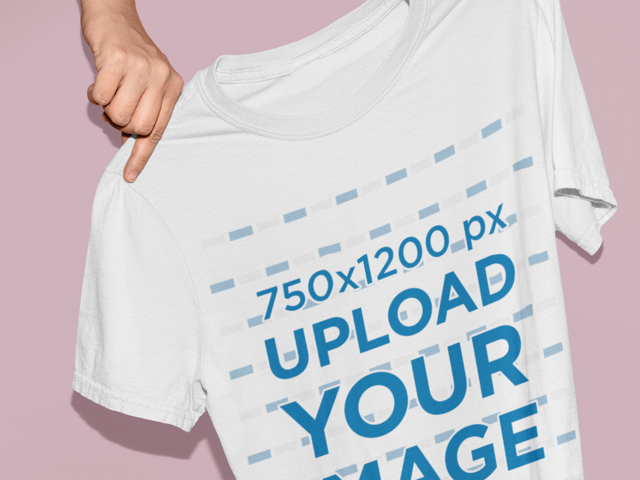Placeit - Mockup of Someone Holding a T-Shirt in Front of a Colored ...