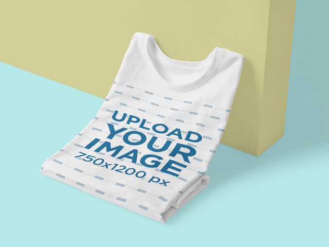Placeit - Mockup of a Folded T-Shirt Placed Against a Colored Wall