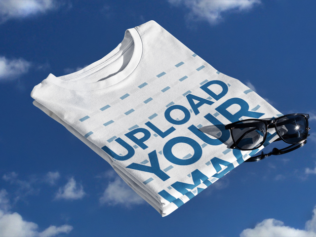 Placeit - Mockup Featuring a Folded Tee and a Sky Background