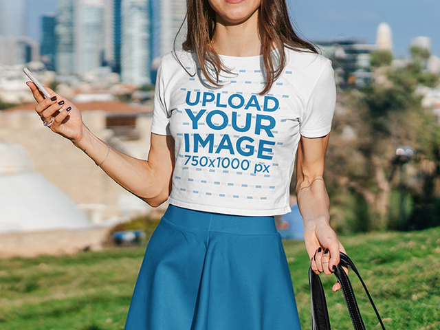Placeit - Crop Top Mockup Featuring a Woman Posing Against a Big City ...