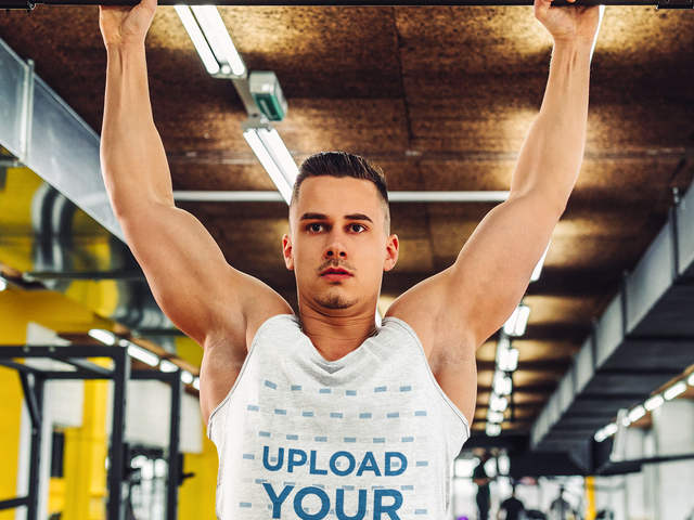 Placeit - Tank Top Mockup of a Muscular Man Doing Pull-Ups at the Gym