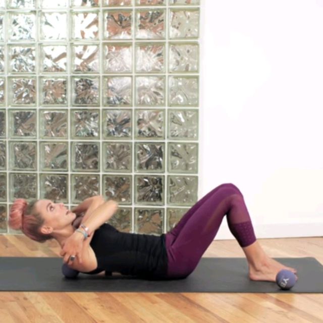 Grasp your shoulders and smoothly roll the ball left and right, up and ...