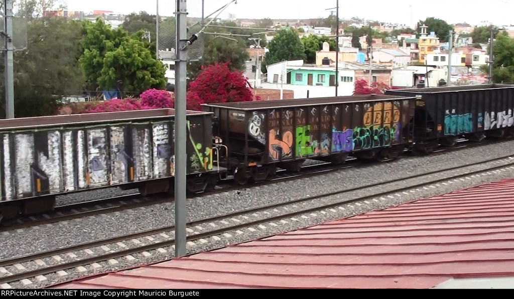 Open Hoppers with graffiti on a MOW train