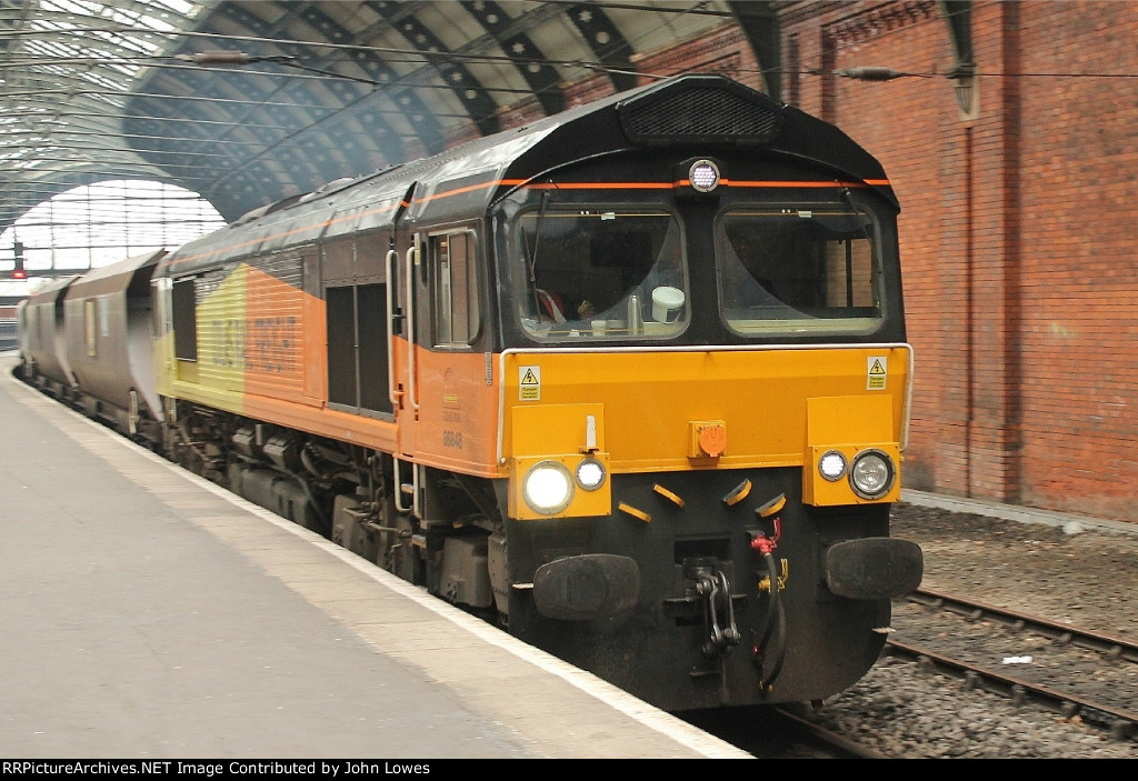 Colas rail 66848 passing through the station with a southbound coal train