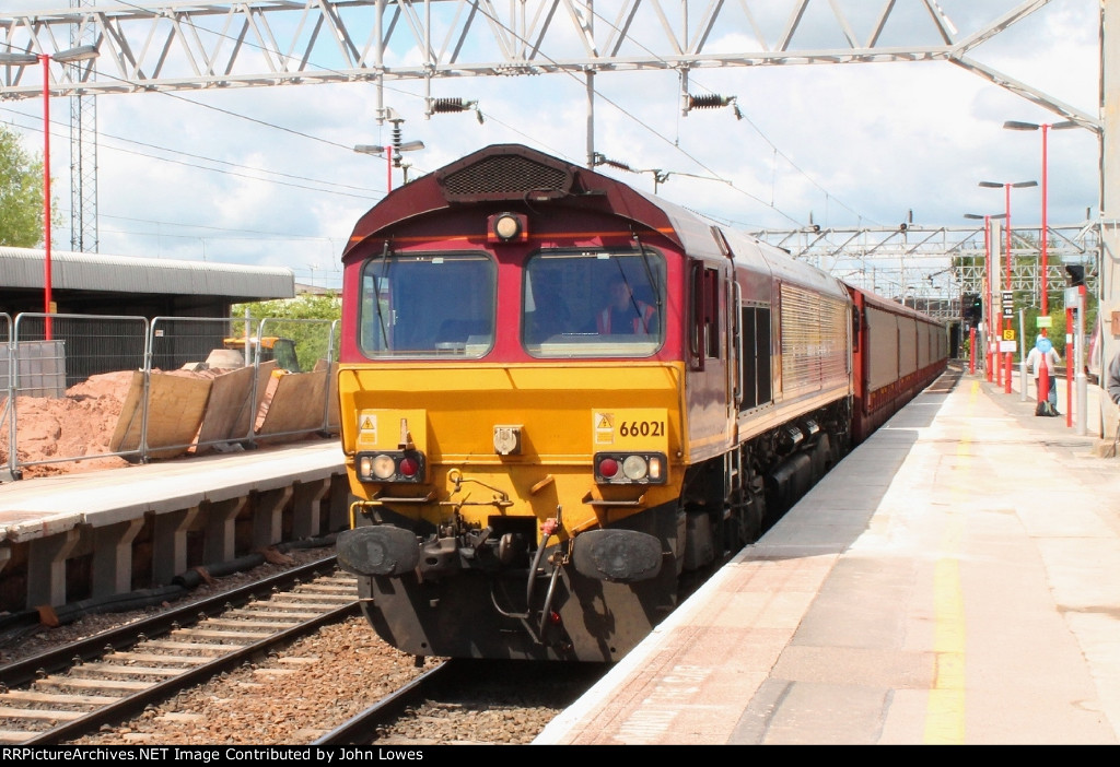 A southbound train of Land Rover cars pulled by EWS 66021