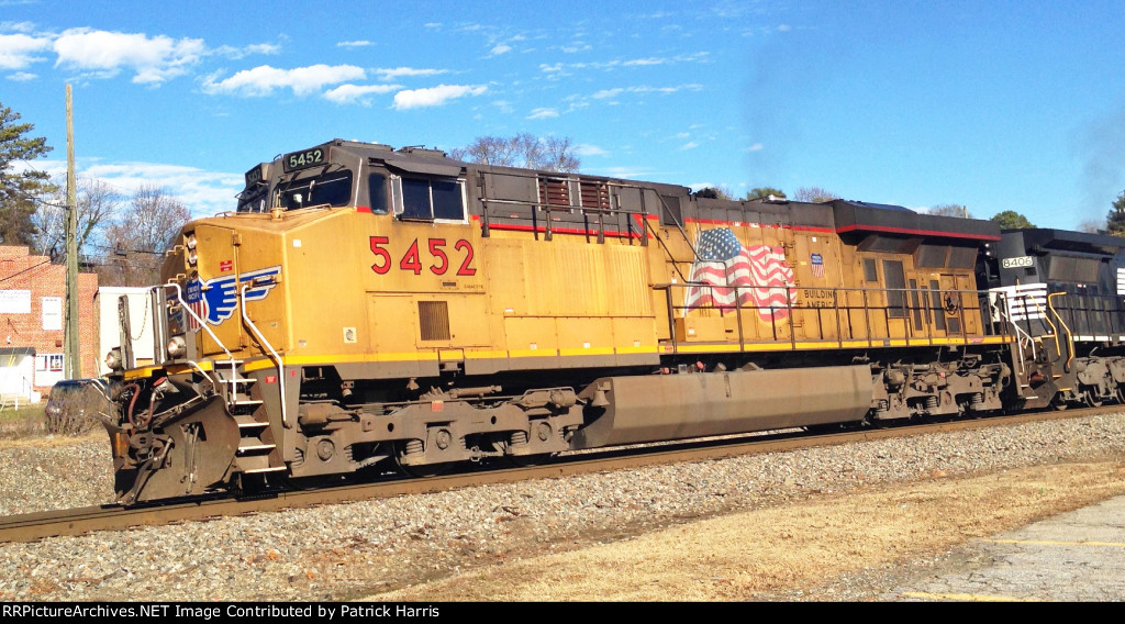 UP 5452 AC45CCTE leads C40-8W and an NS unit grain train westbound on ...